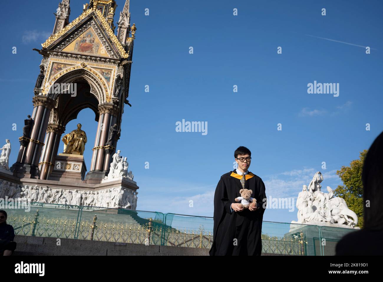 A young Asian graduate from Imperial College celebrates their education ...