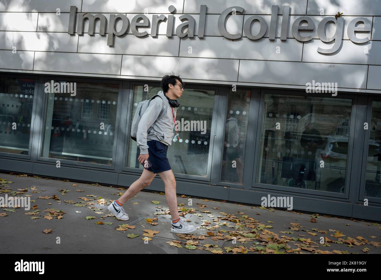An Asian student walks past Imperial College London, on 19th October ...