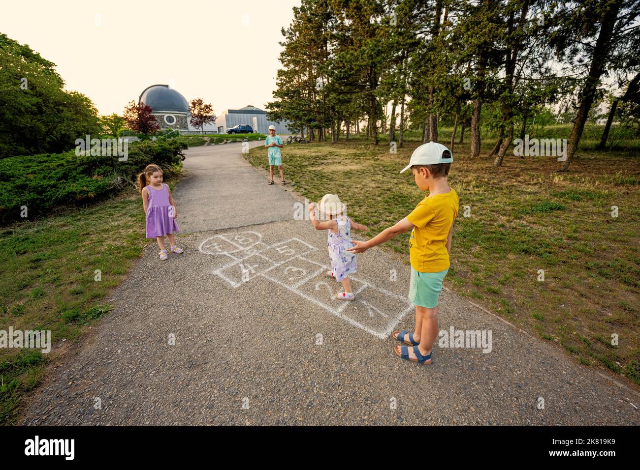 Kids playing hopscotch in park. Children outdoor activities Stock Photo ...