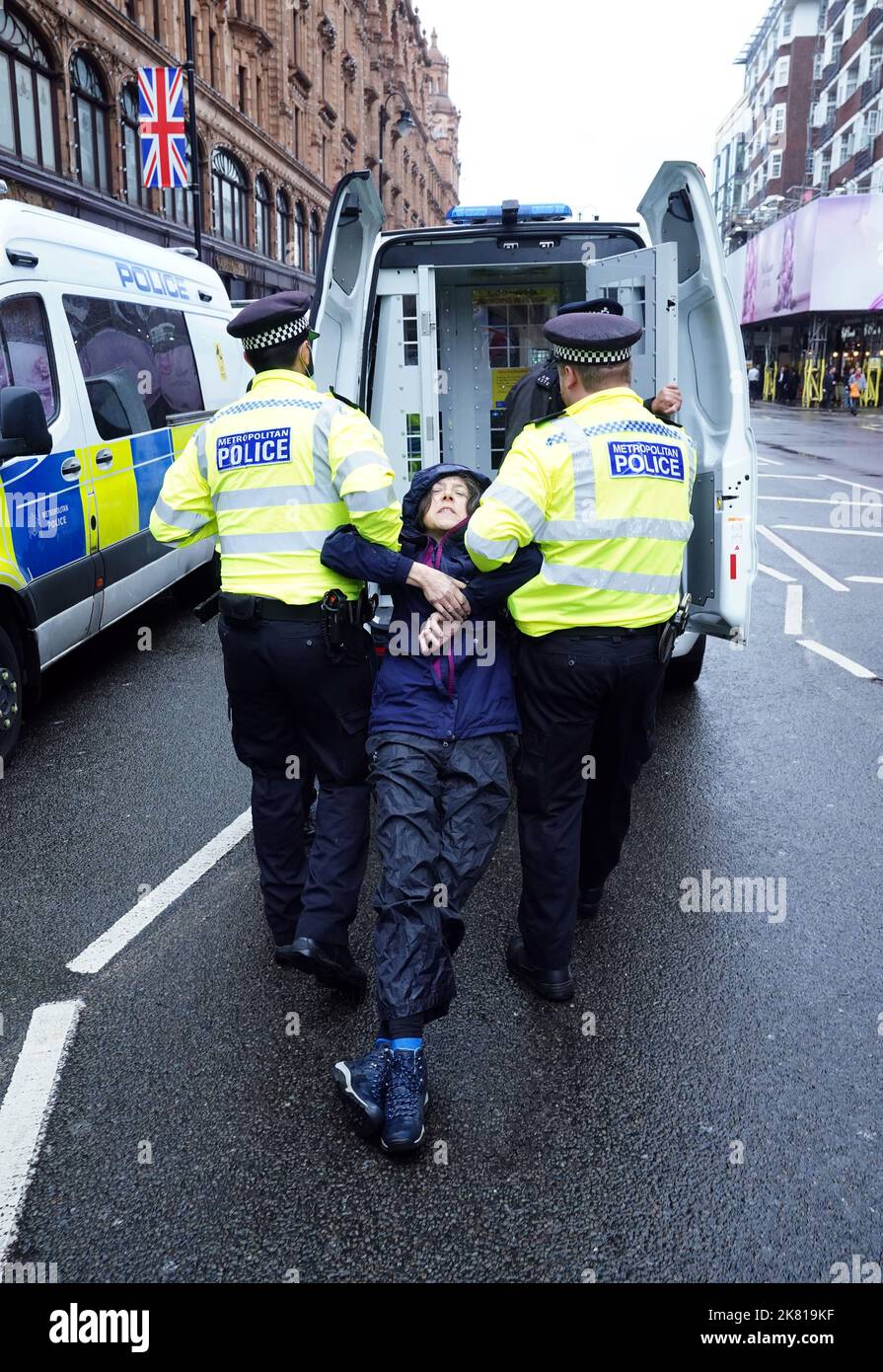 Police officers deal with activists from Just Stop Oil during their ...