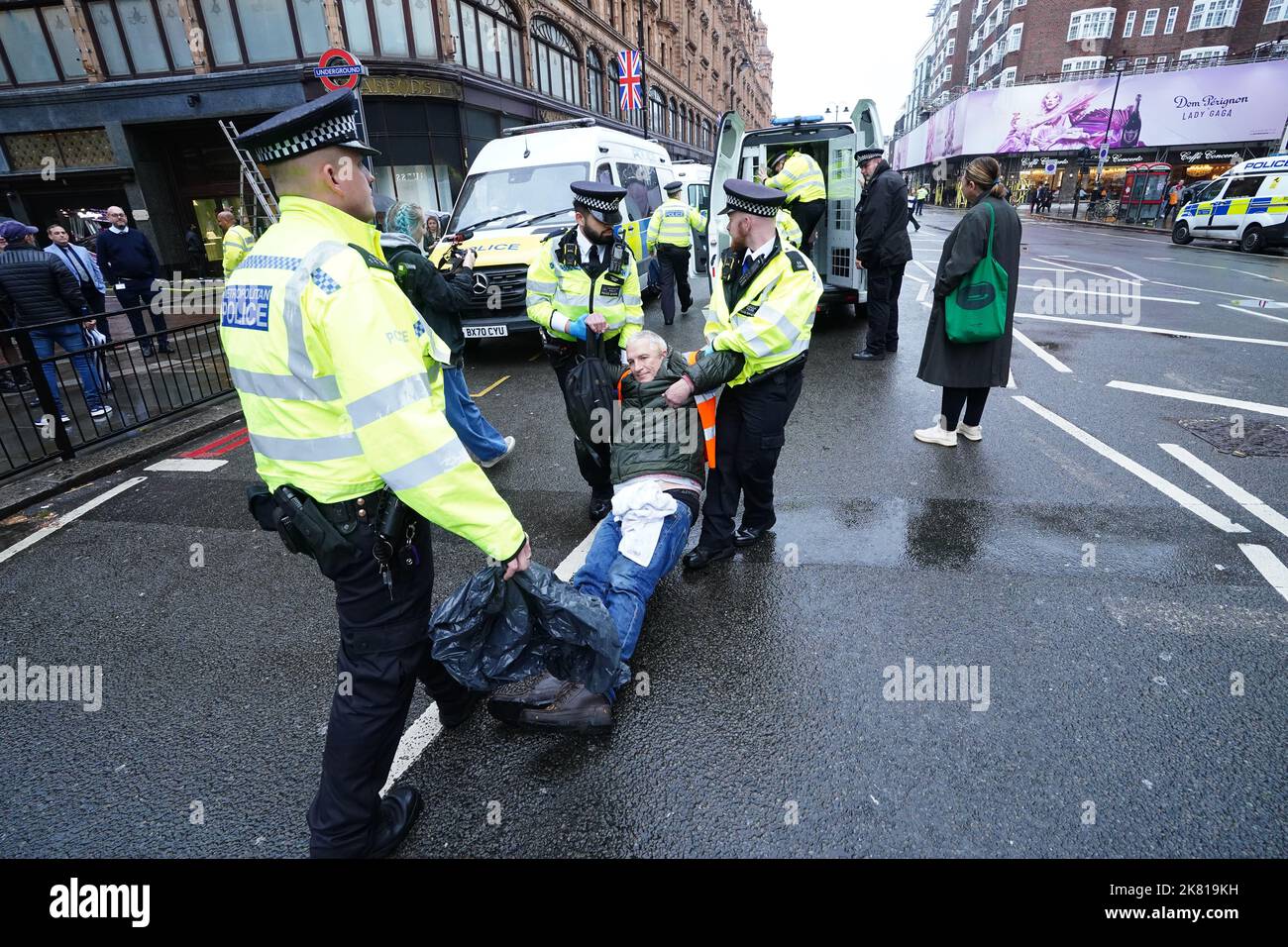 Police officers deal with activists from Just Stop Oil during their ...