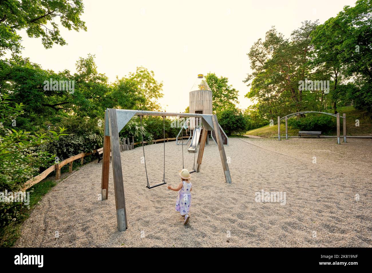 Baby girl swing in children's playground toy set in public park Stock ...