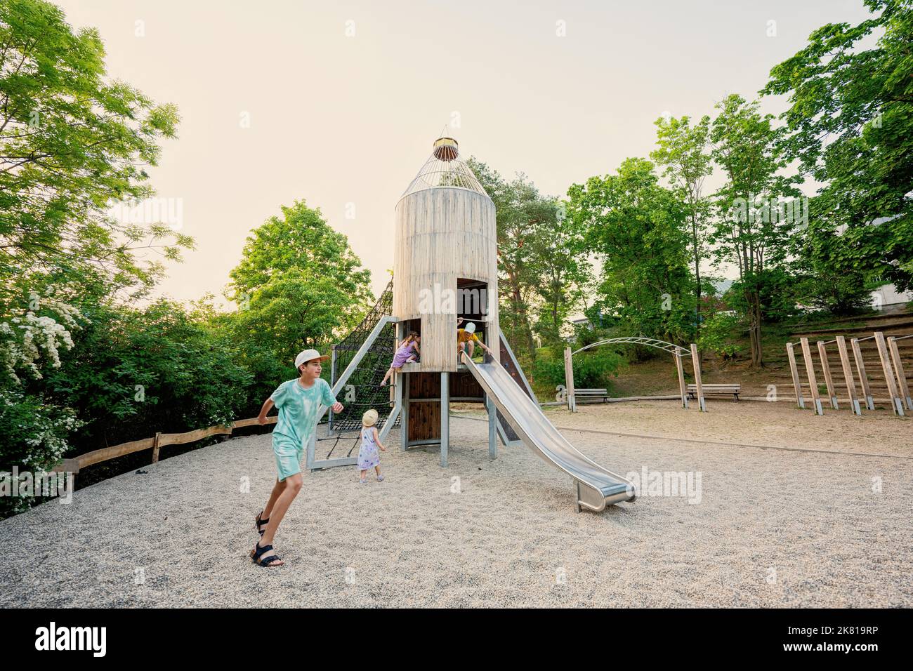 Kids in rocket slide children's playground toy set in public park Stock ...
