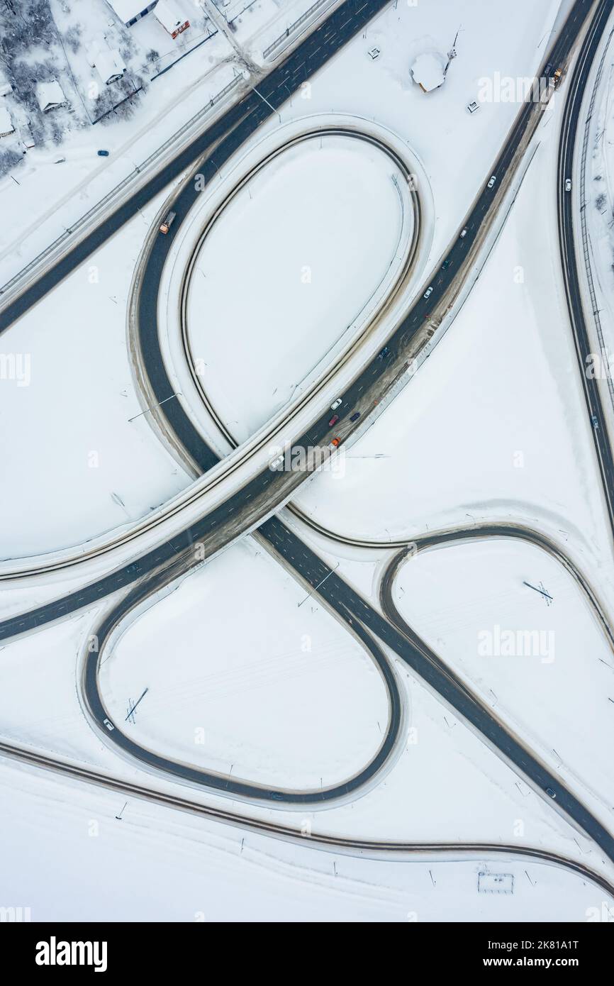 Aerial top view of road junction in winter. Intersection looks like ...
