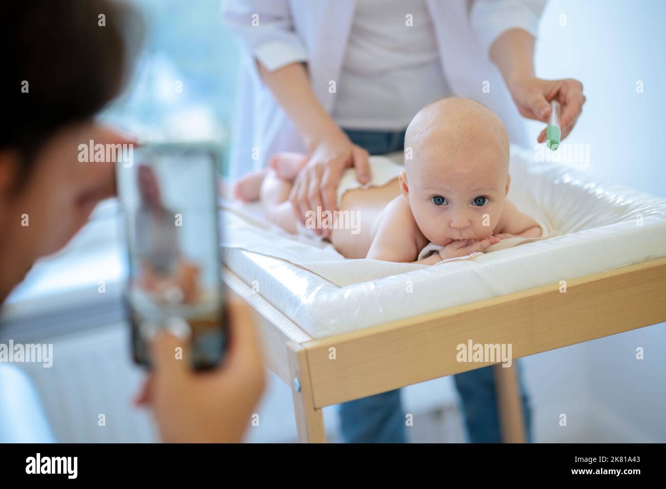 Baby being examined by a neonatal doctor in a clinic Stock Photo - Alamy