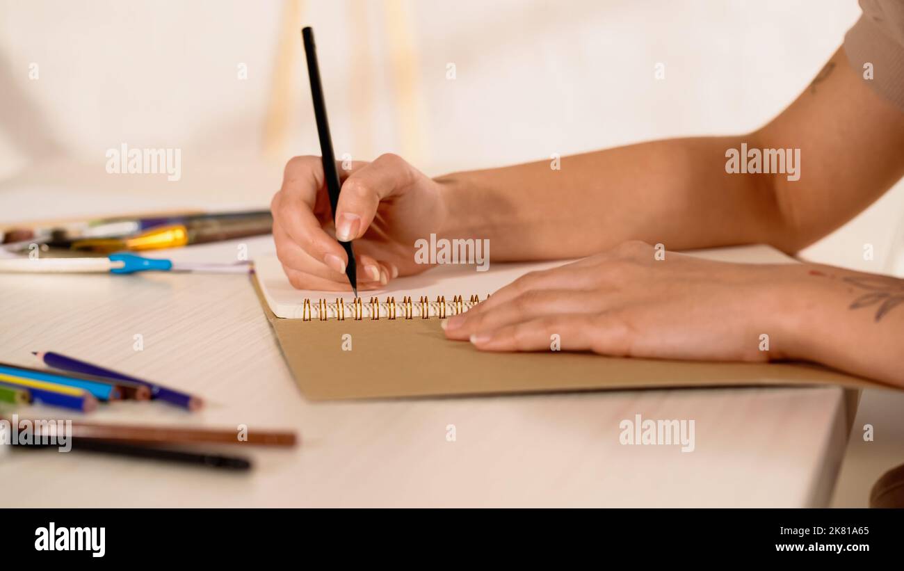 Cropped view of tattooed woman drawing on sketchbook,stock image Stock ...