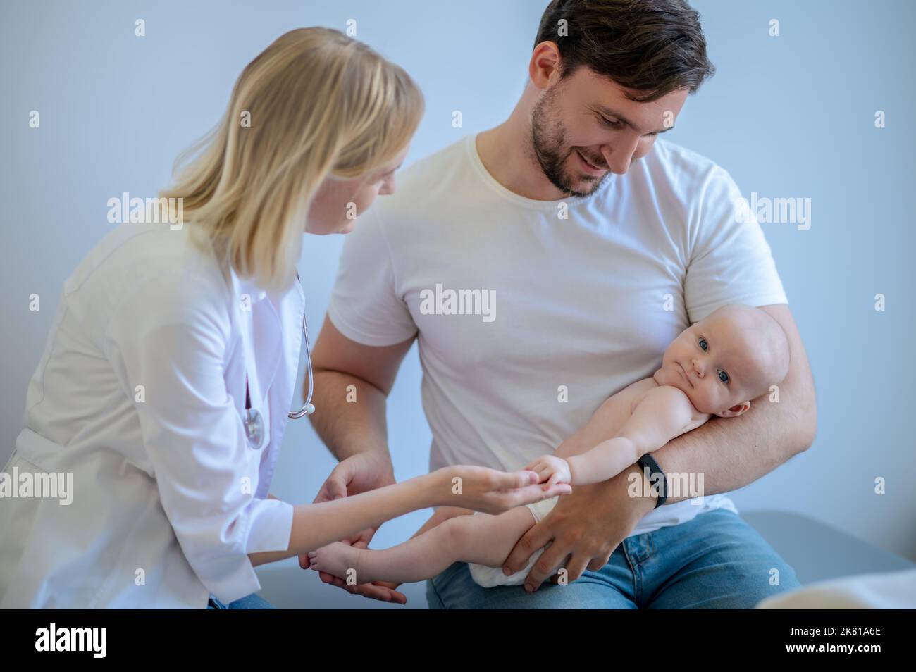 Experienced neonatal doctor examining a newborn child Stock Photo - Alamy