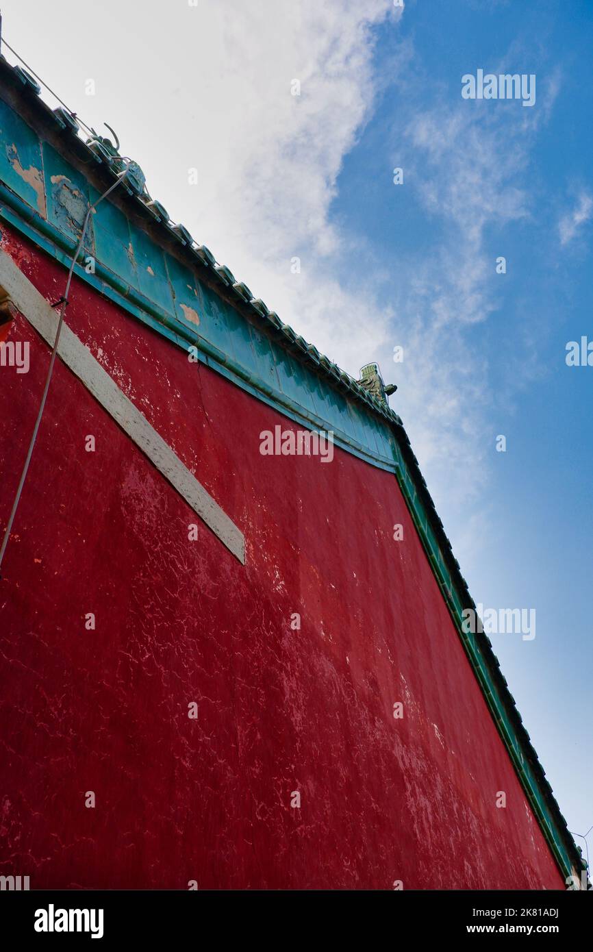The vertical minimalistic view of the wall of red Pudu temple in ...