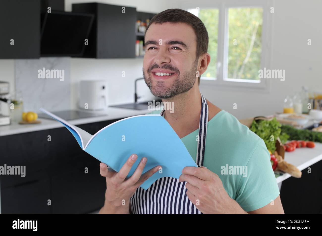 Man reading some notes before making some food in the kitchen Stock ...