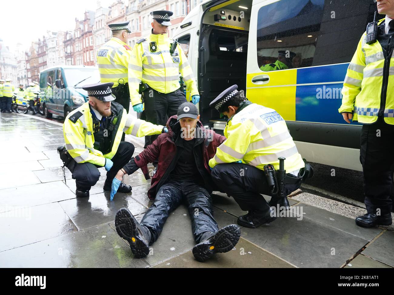 Police officers deal with activists from Just Stop Oil during their ...