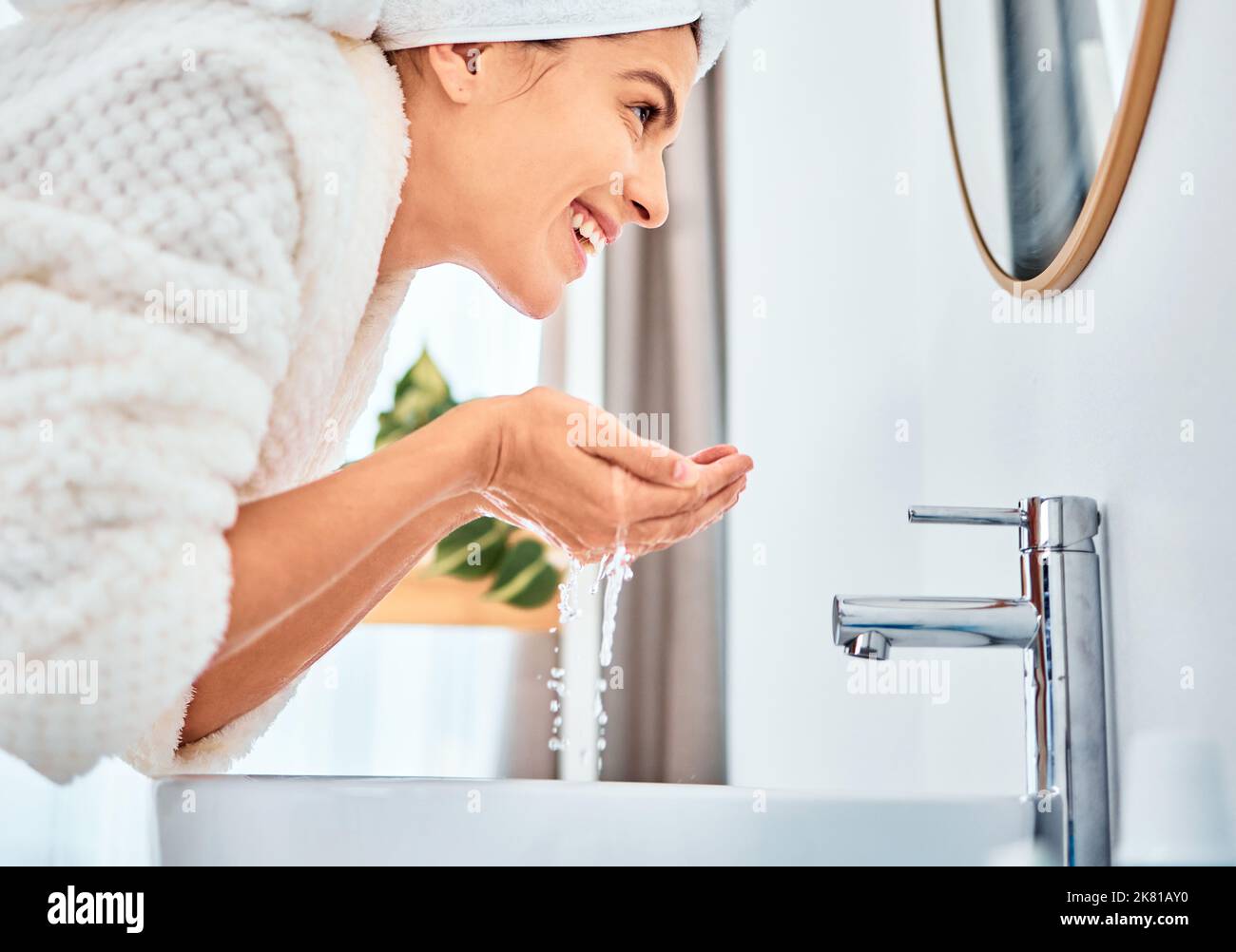 Remember to thoroughly cleanse your skin. a young woman washing her ...