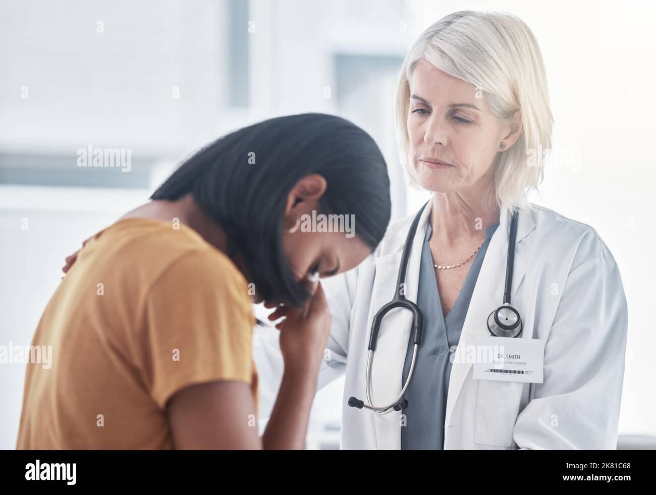 Im sorry to have to tell you this. a doctor consoling an unhappy ...