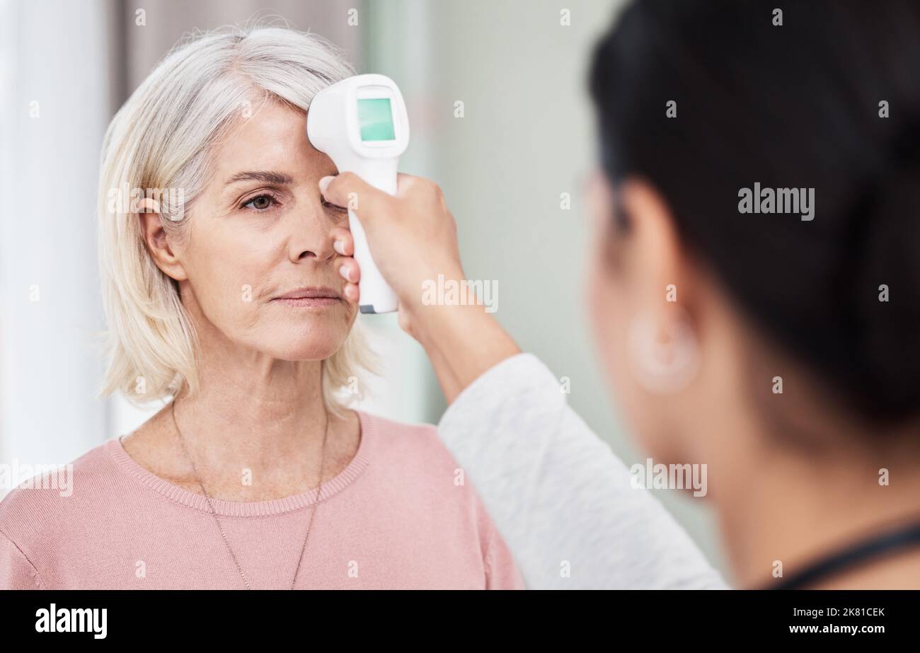 Your temperature will determine the next step. a senior woman having ...