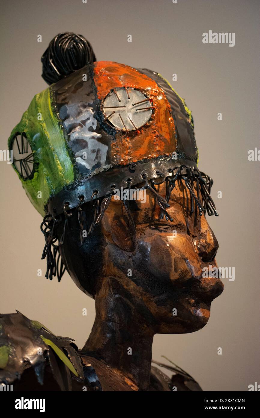 A vertical shot of a bronze statue head of an African Traditional ...