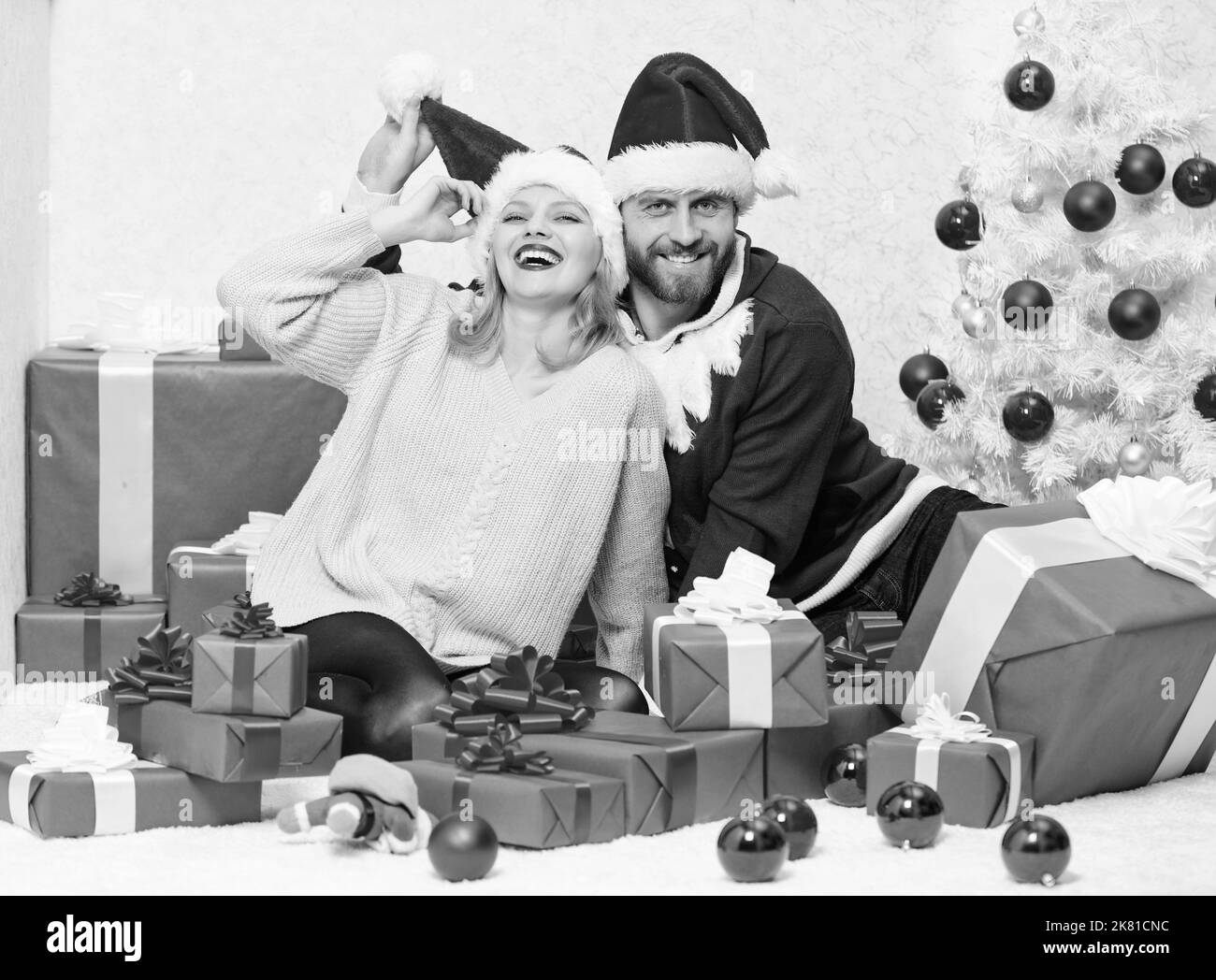 Couple wear hats as santa claus christmas tree background. It is easy ...