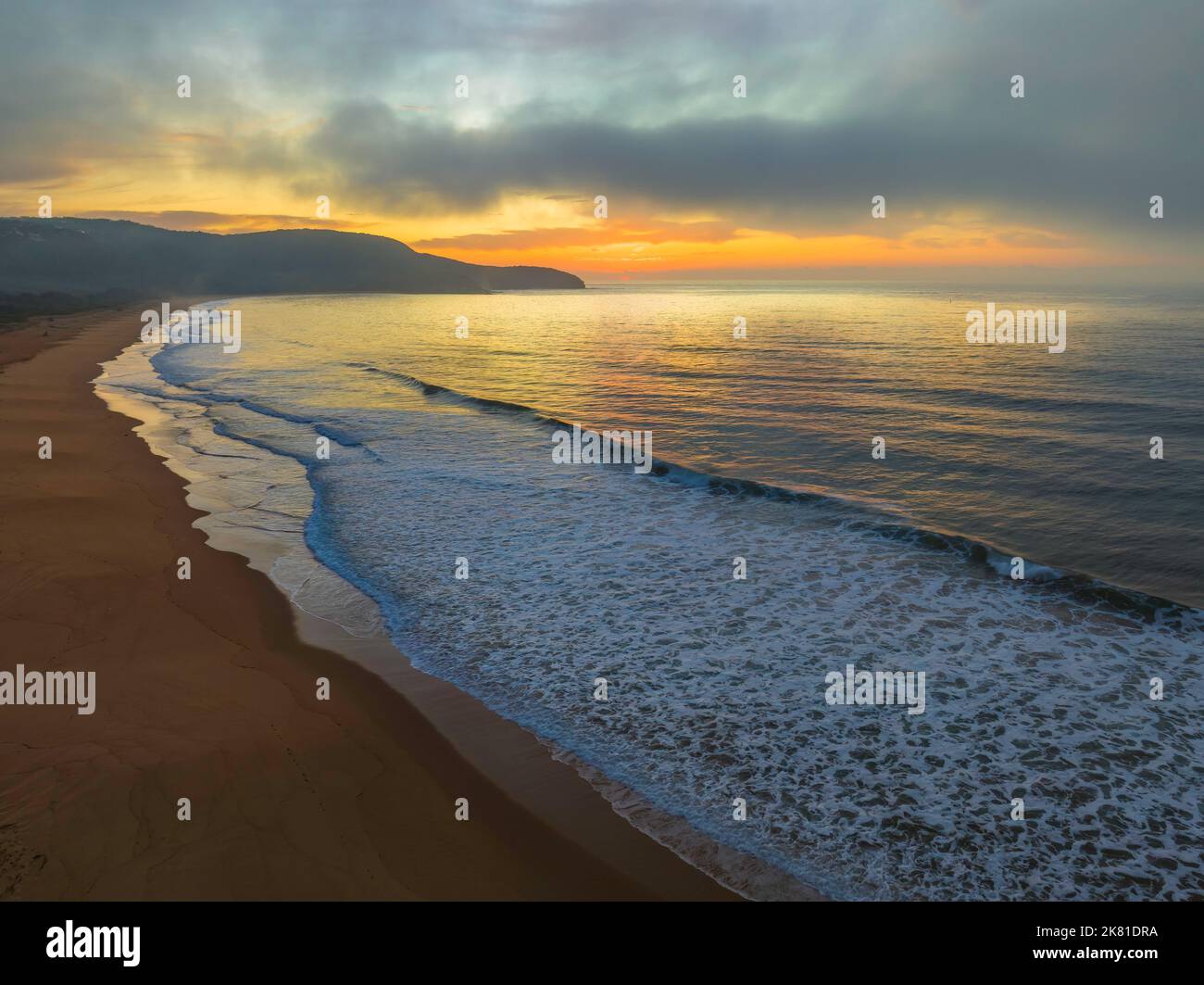 Aerial sunrise at the seaside with the sun rising on the horizon at ...