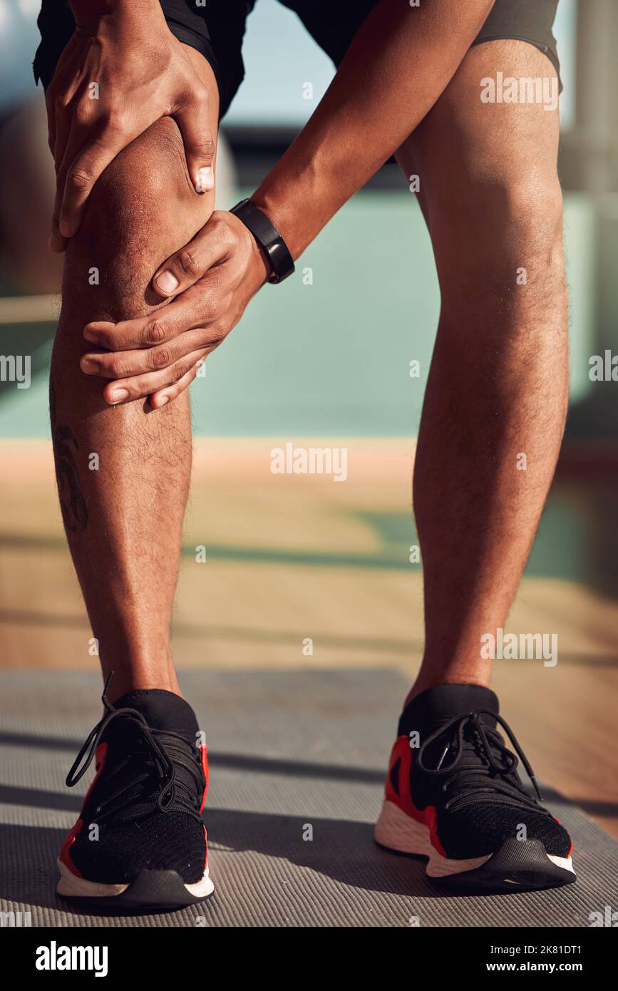 My knee is acting up again. a man taking a break from a workout to ...