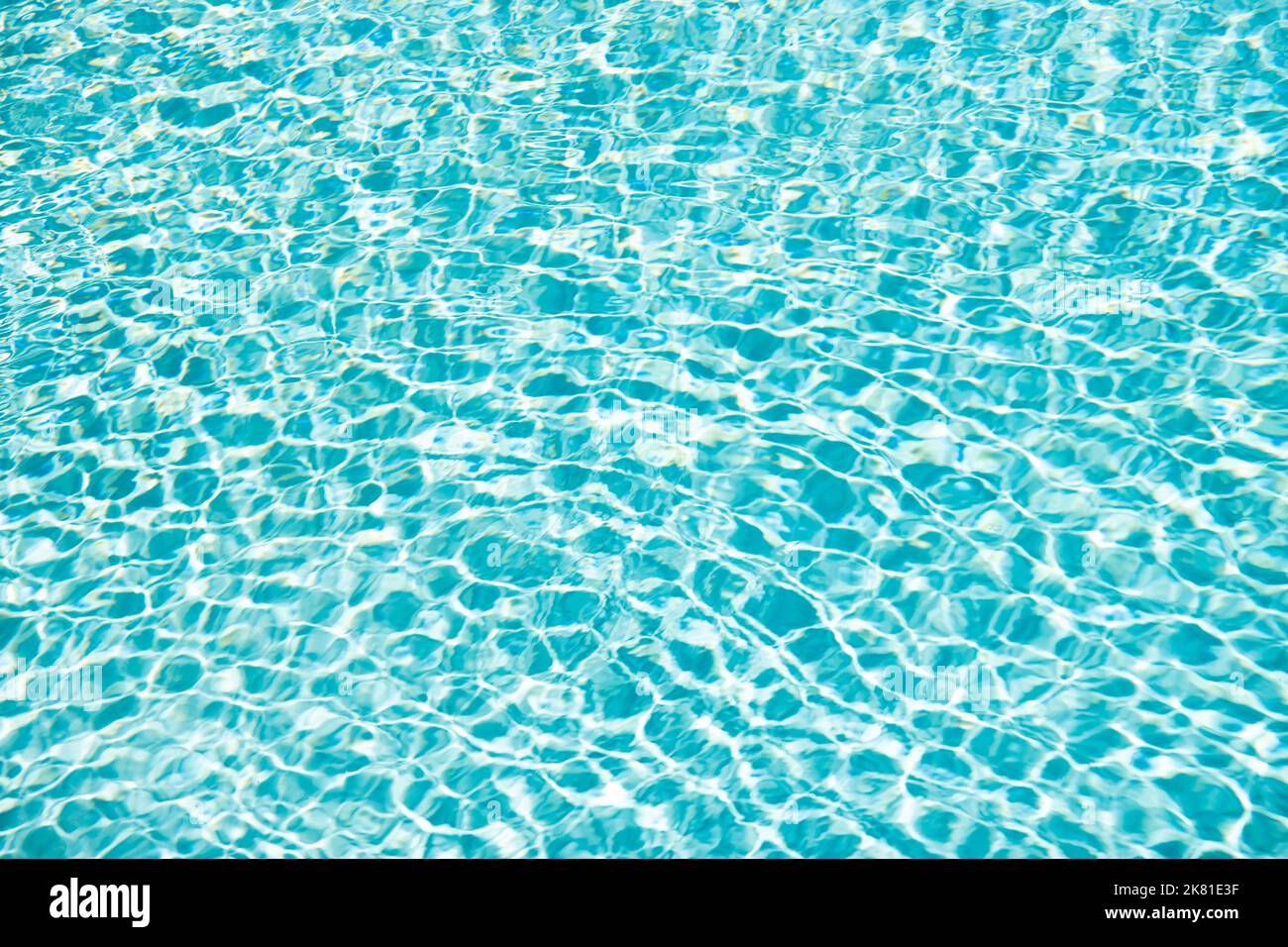 turquoise color background of swimming pool water with ripples on ...