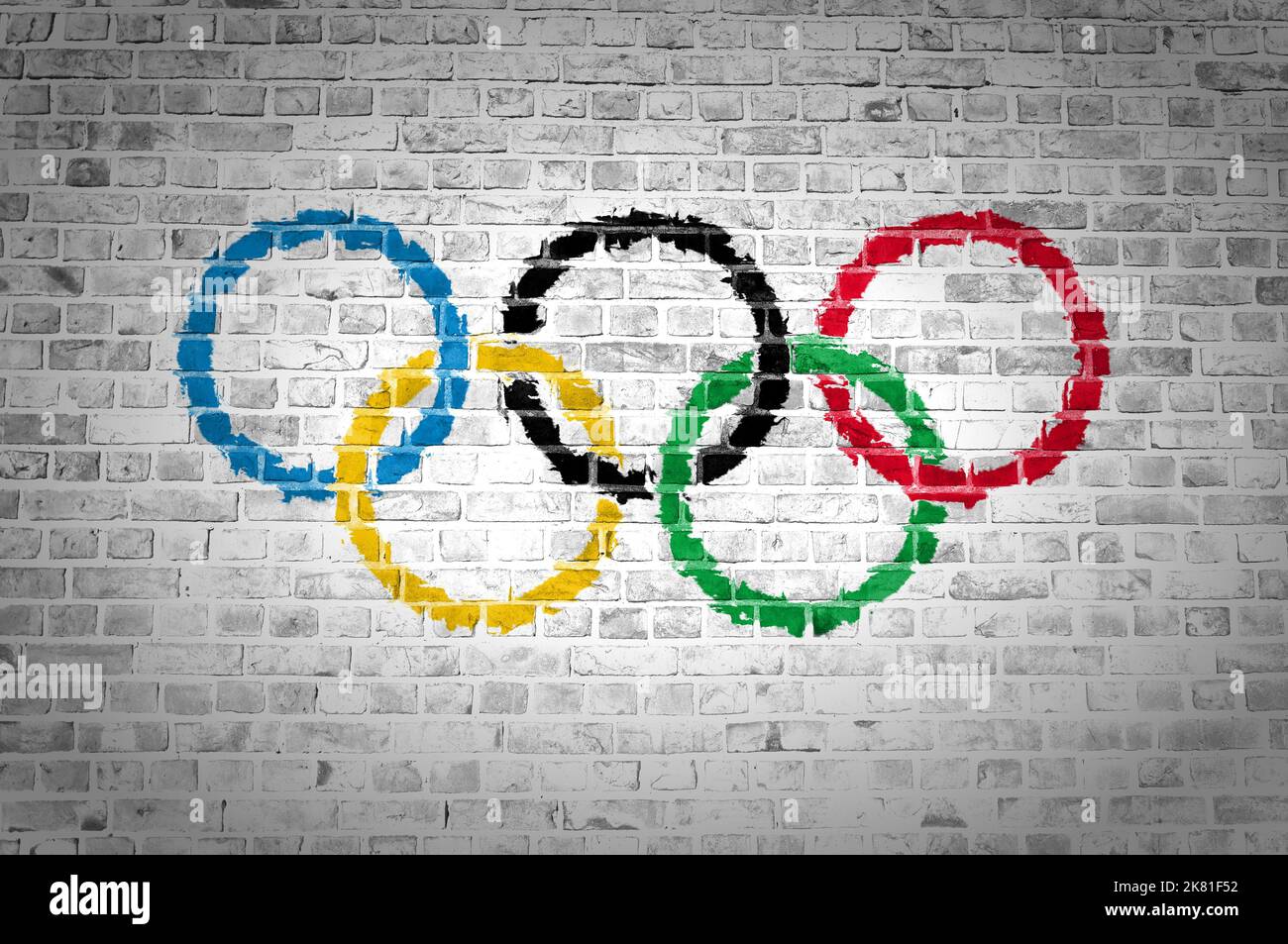 An image of the Olympic Movement flag painted on a brick wall in an ...