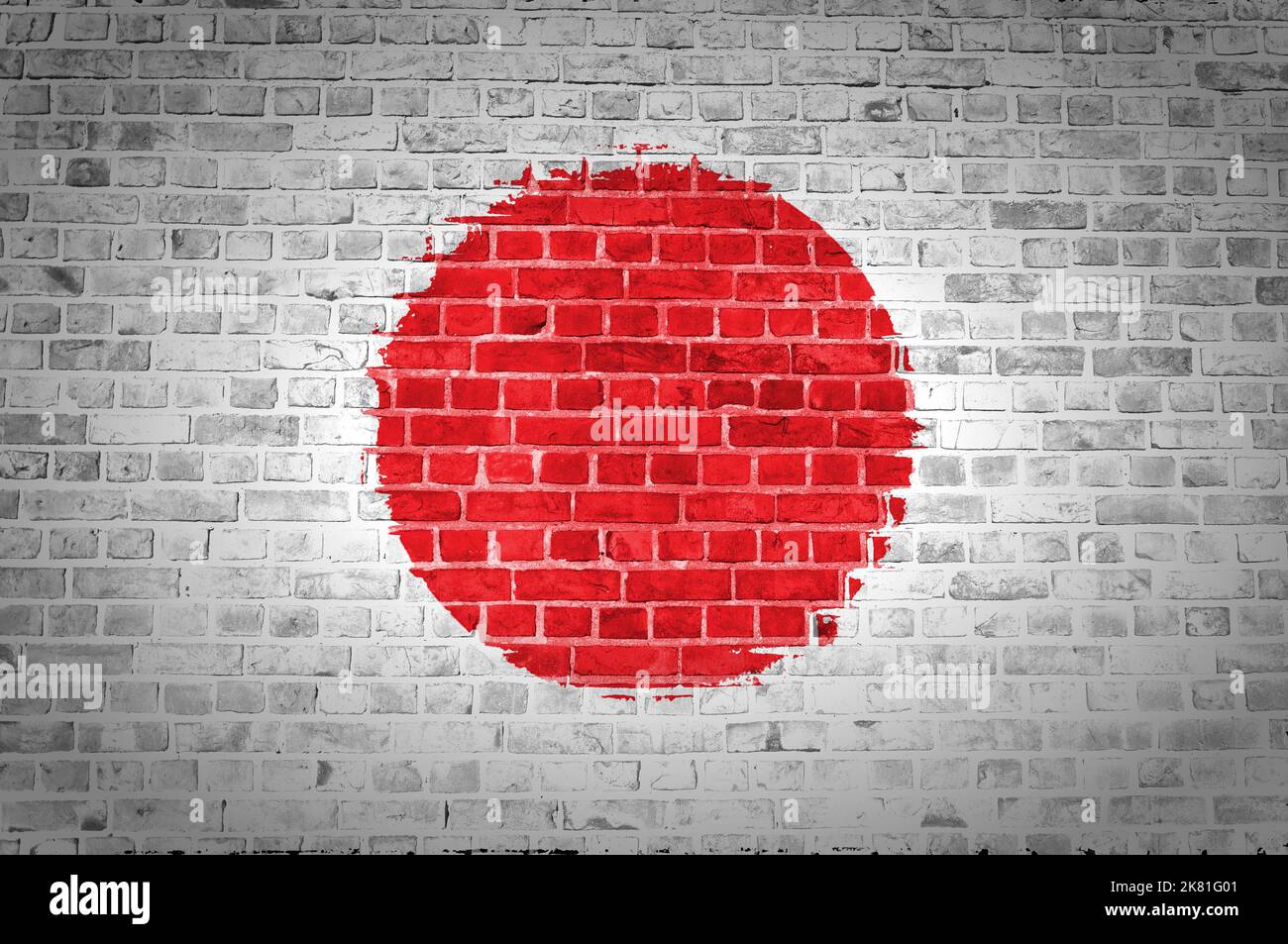 An image of the Japan flag painted on a brick wall in an urban location ...