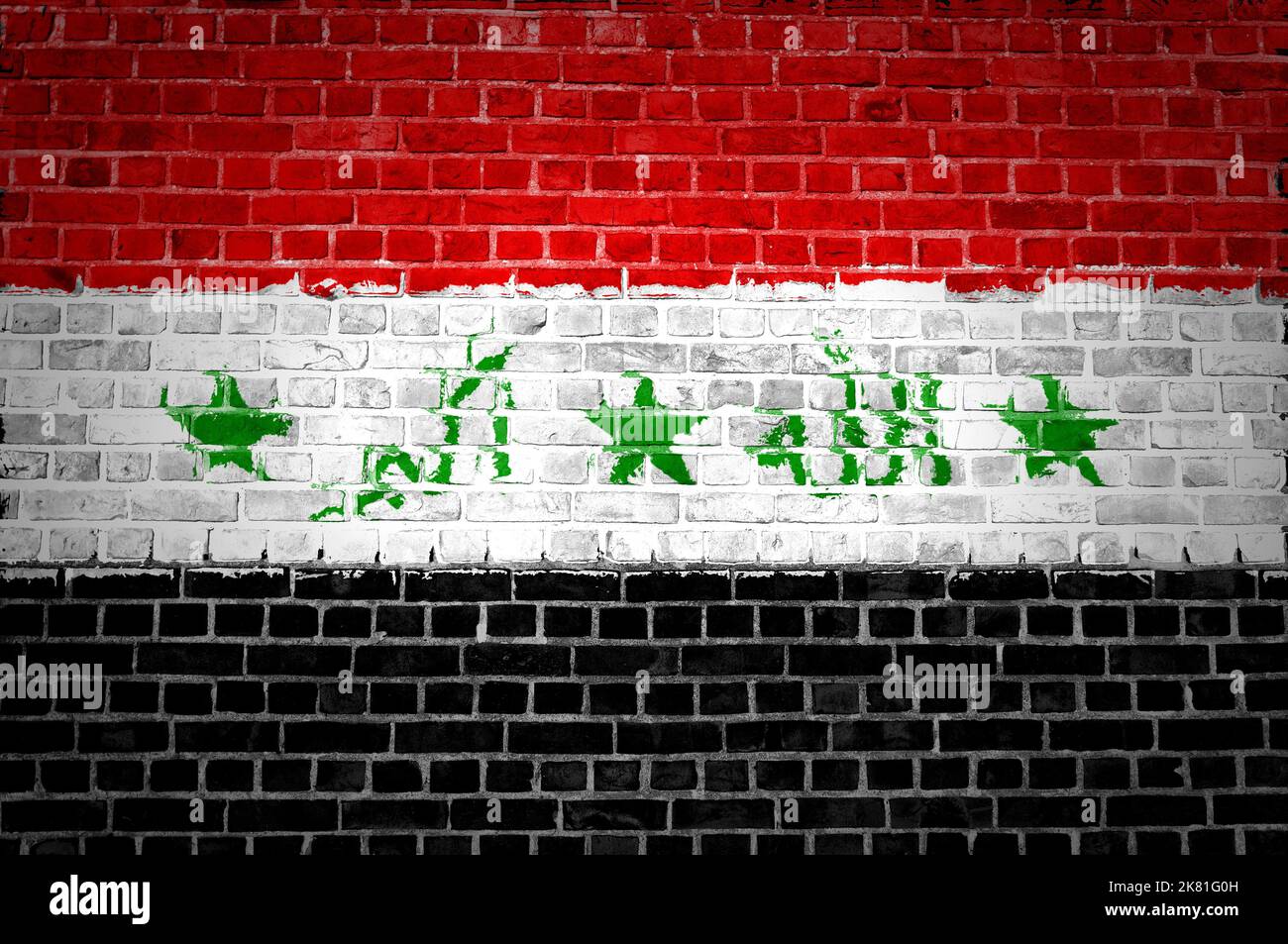An image of the Iraq flag painted on a brick wall in an urban location ...