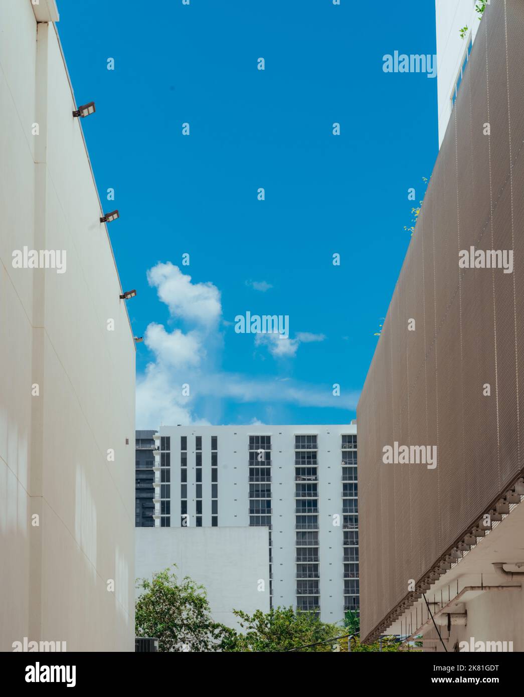 A vertical shot of building walls of a city under a beautiful blue sky ...