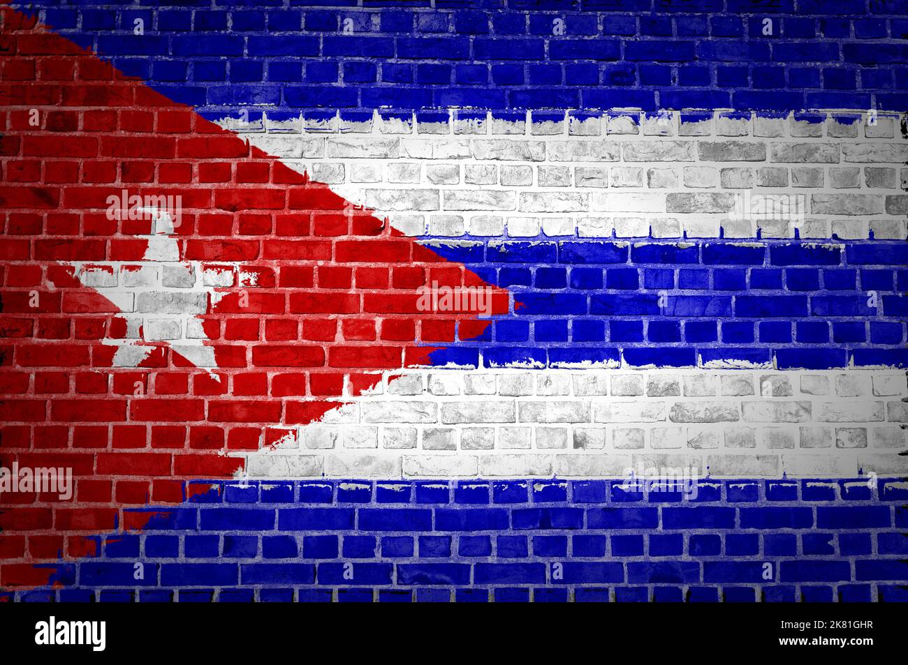 An image of the Cuba flag painted on a brick wall in an urban location ...