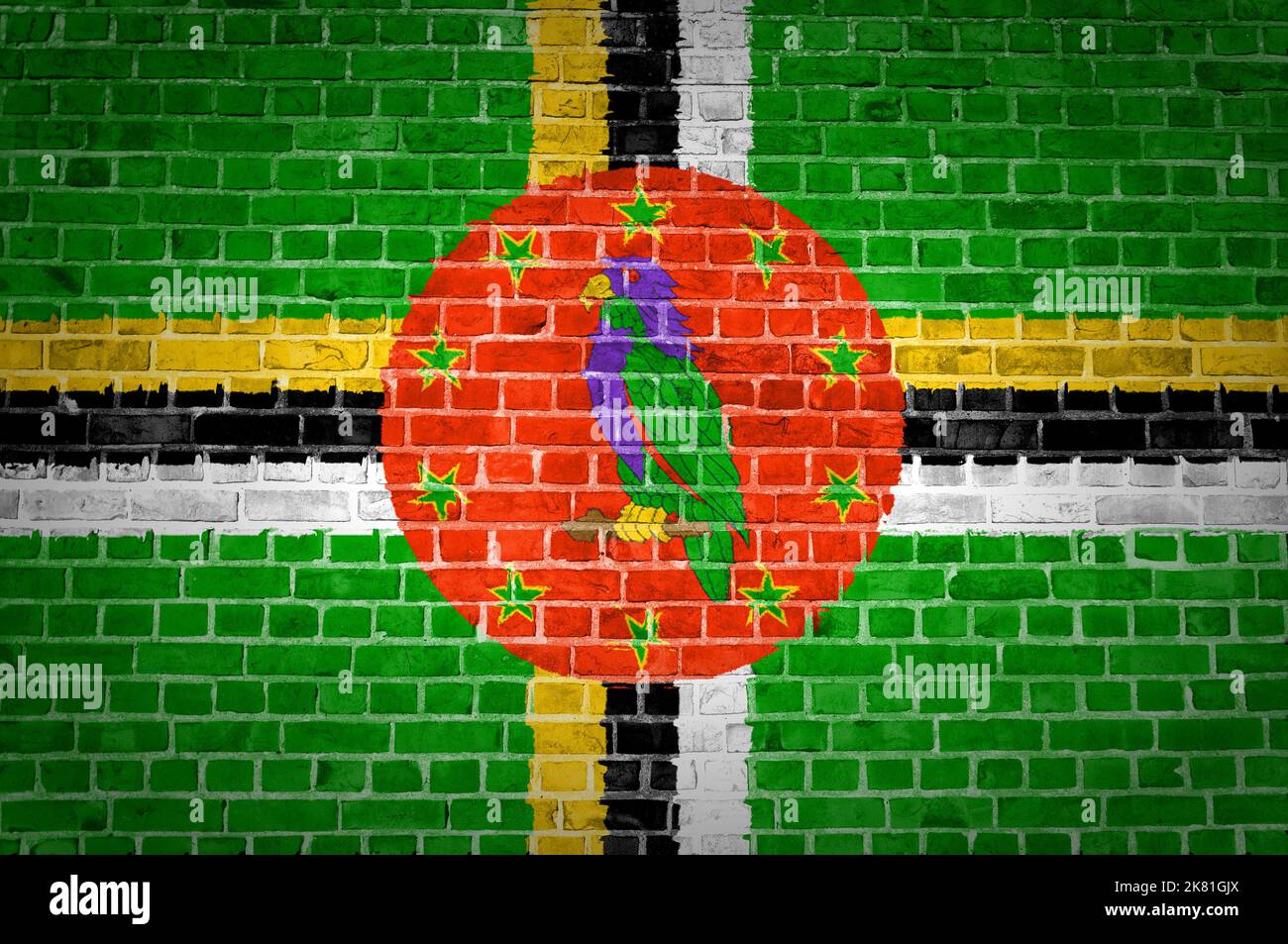 An image of the Dominica flag painted on a brick wall in an urban ...