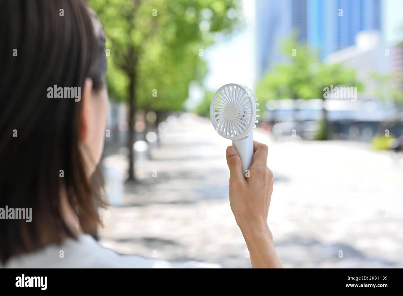 Japanese woman using a portable fan Stock Photo - Alamy