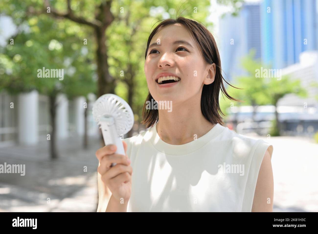 Japanese woman using a portable fan Stock Photo - Alamy
