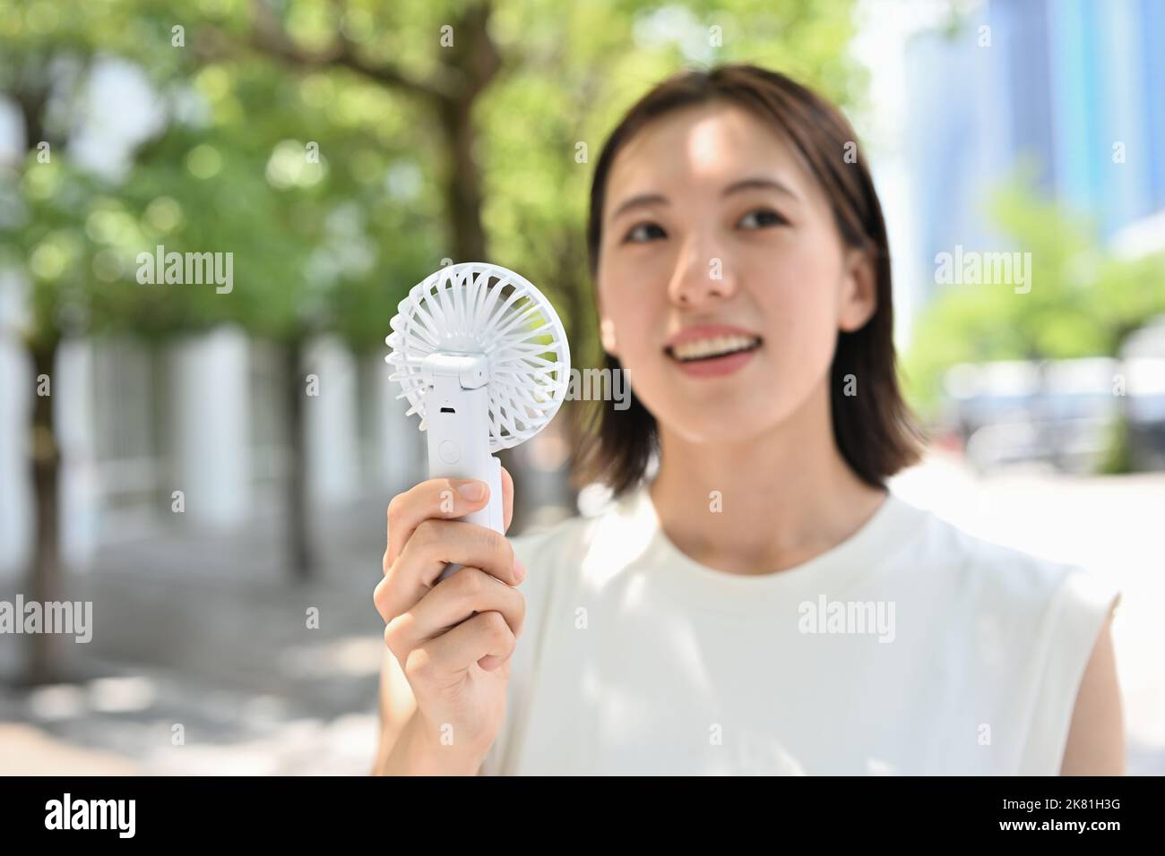 Japanese woman using a portable fan Stock Photo - Alamy