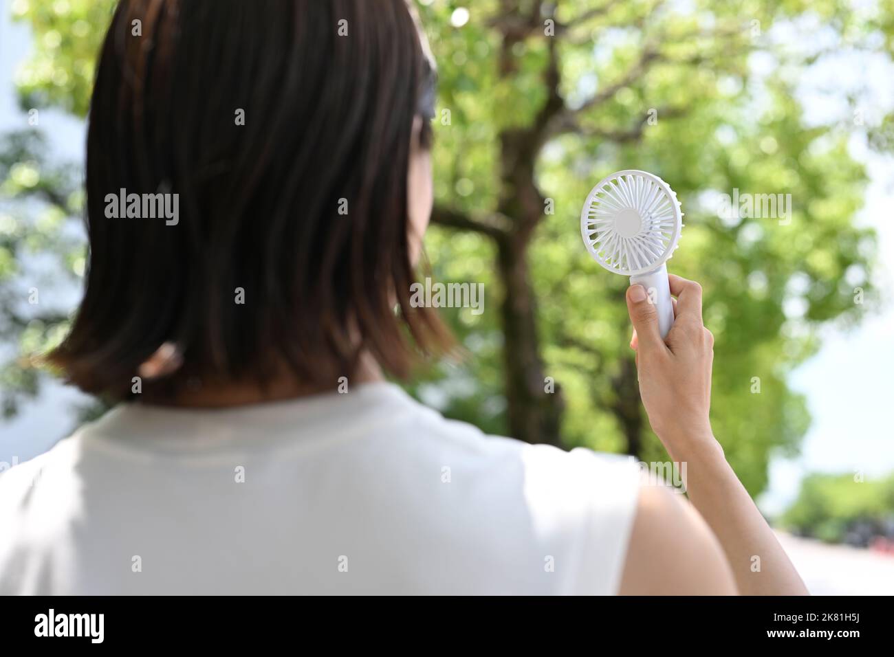 Woman holding portable fan hi-res stock photography and images - Alamy