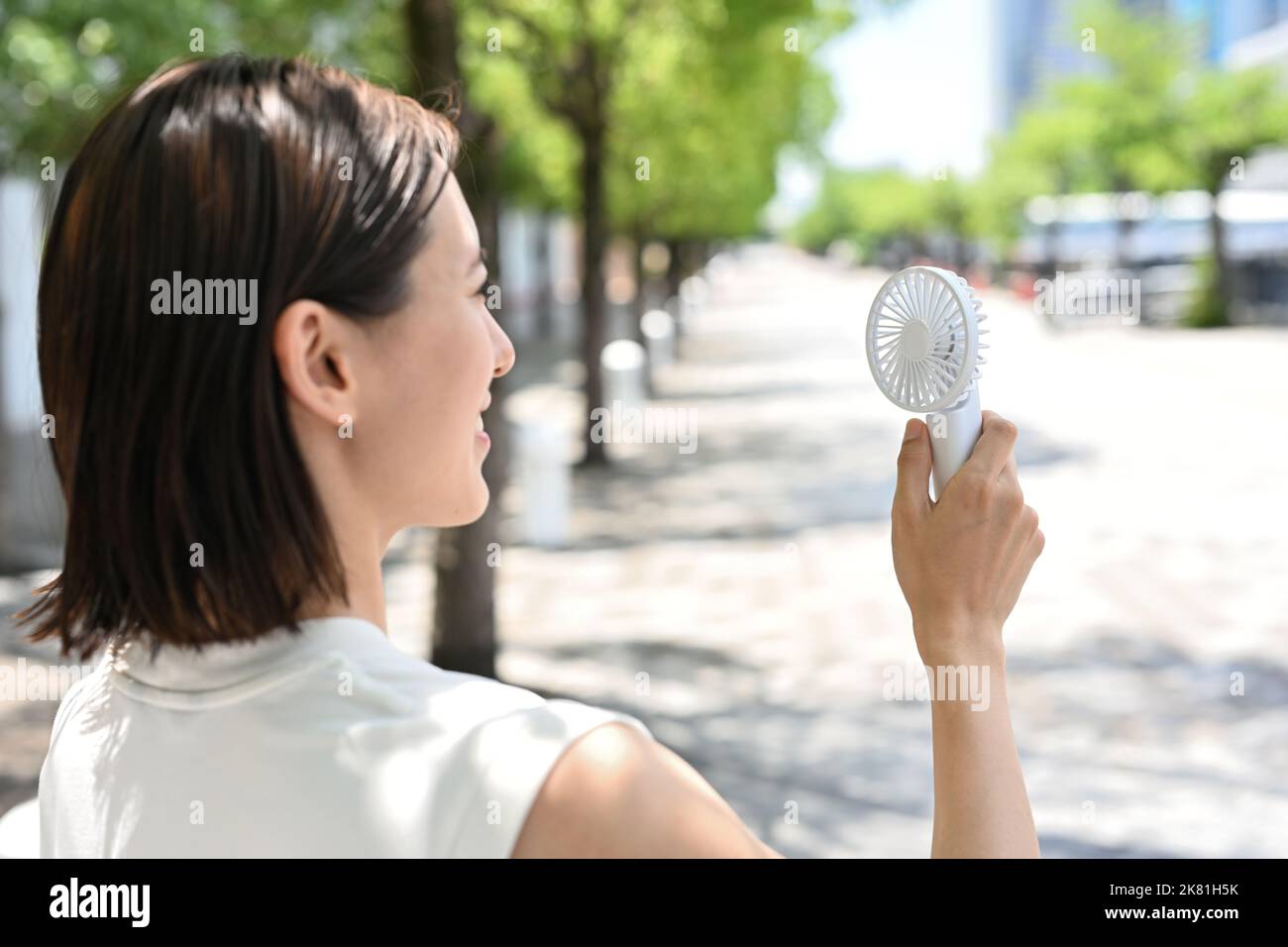 Japanese woman using a portable fan Stock Photo - Alamy