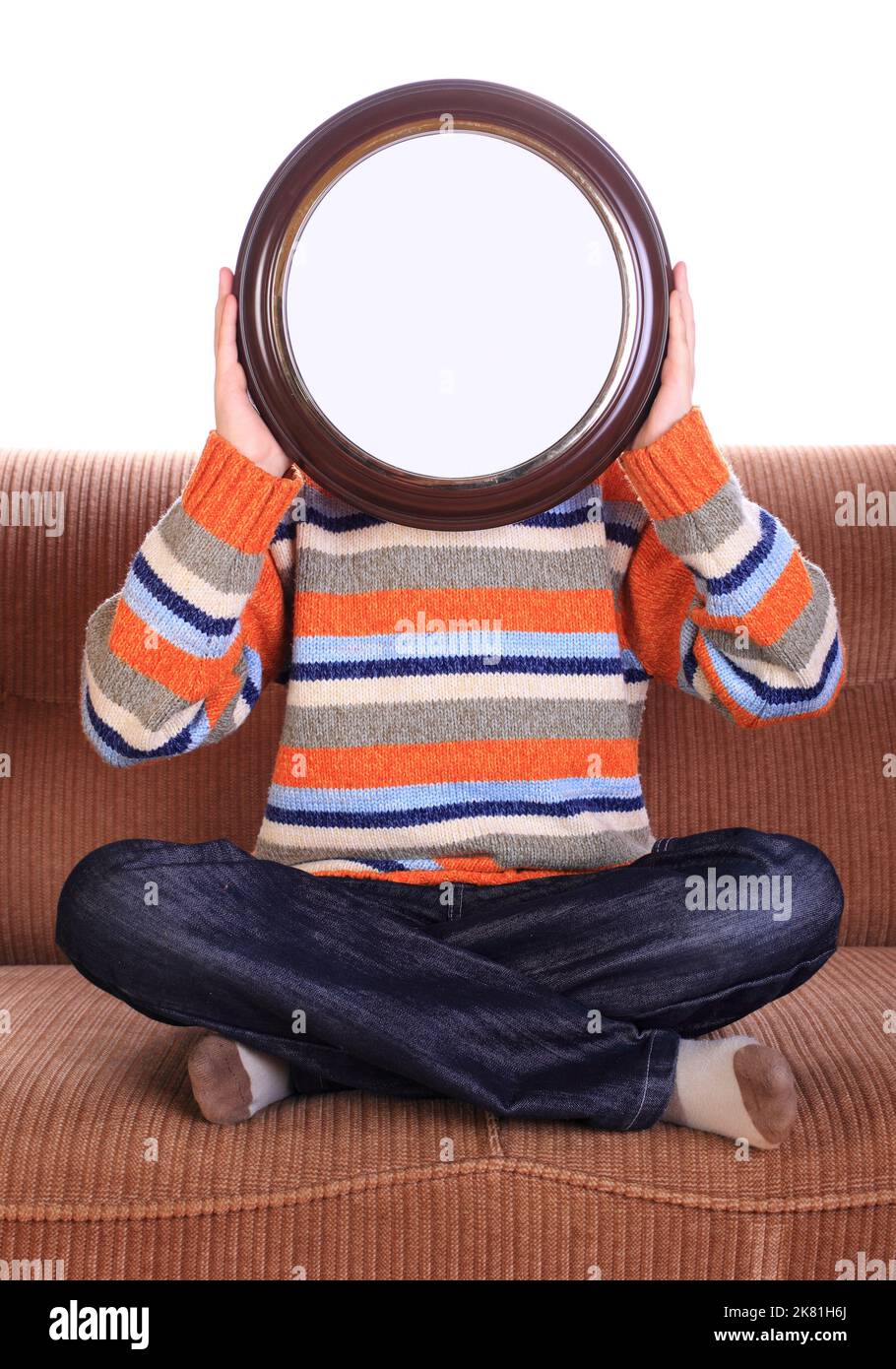 Young child covering face with empty circle object Stock Photo - Alamy