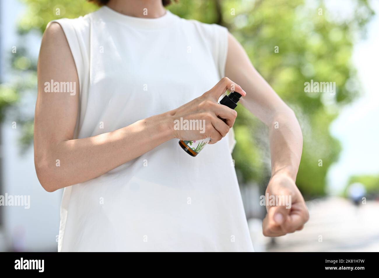 Japanese woman using insect repellent Stock Photo - Alamy