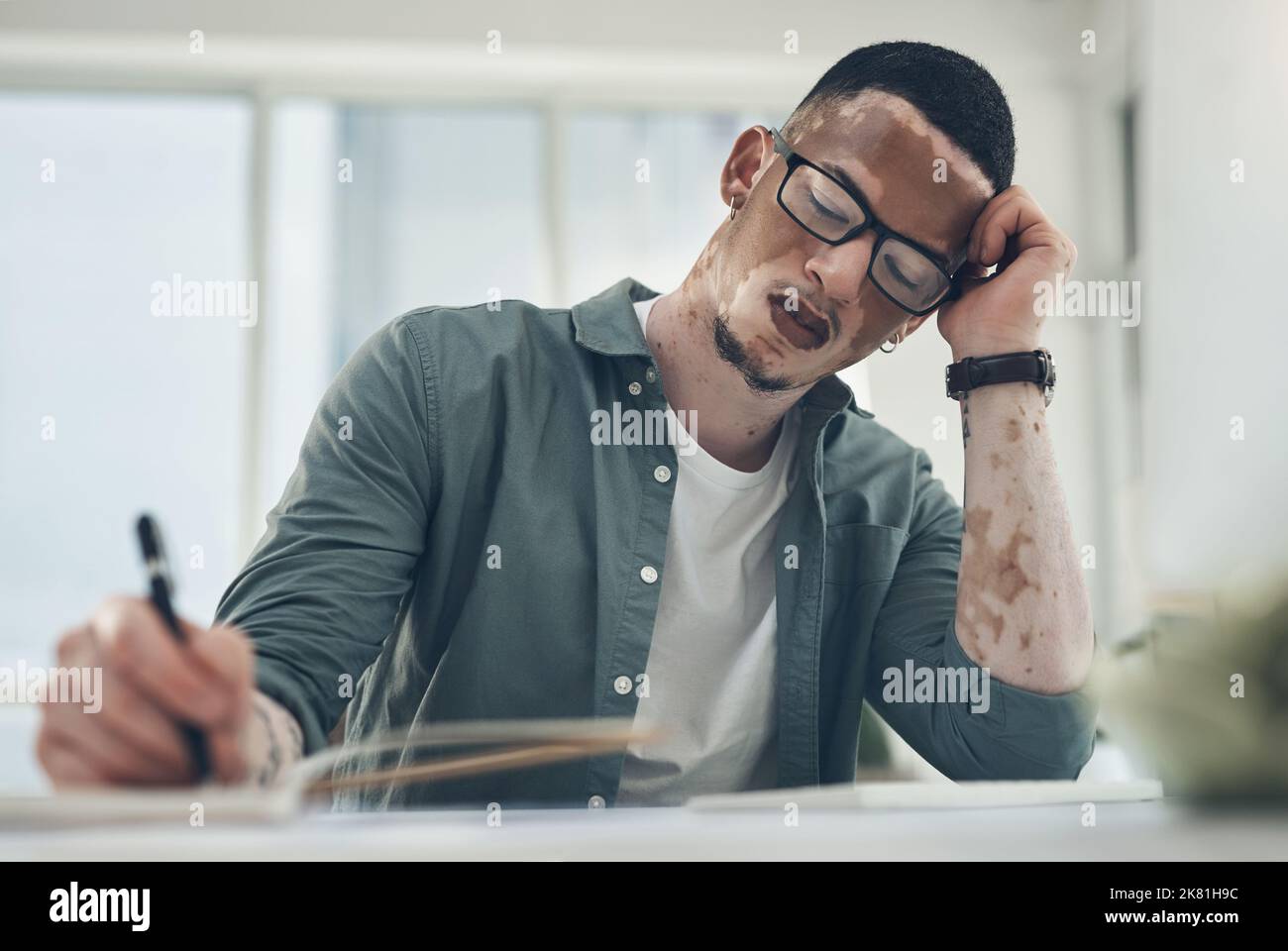 Push through the pain of failure. a young business man working in a ...