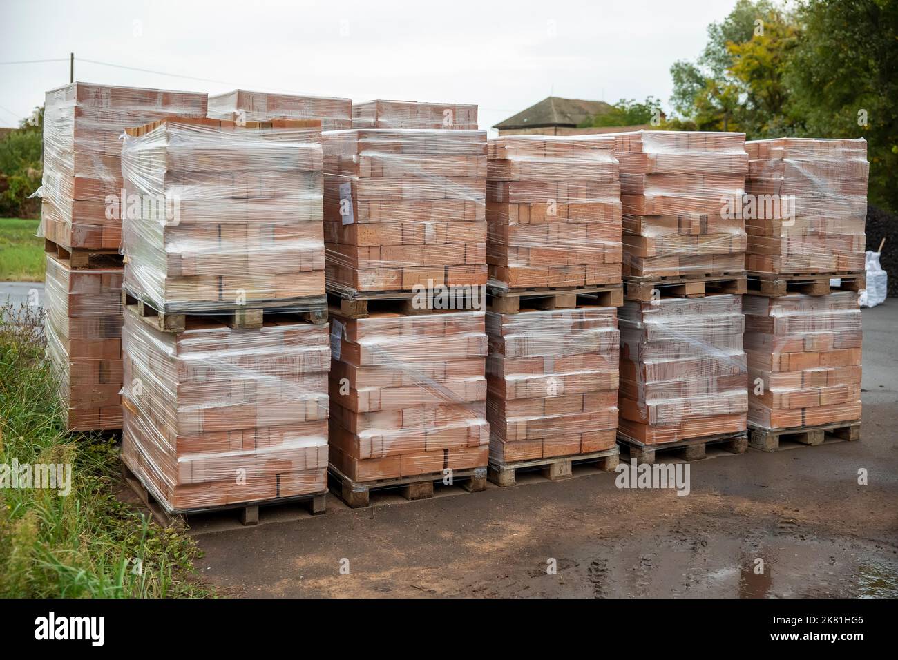 Red brick packaged with plastic foil on pallets in brick factory Stock ...