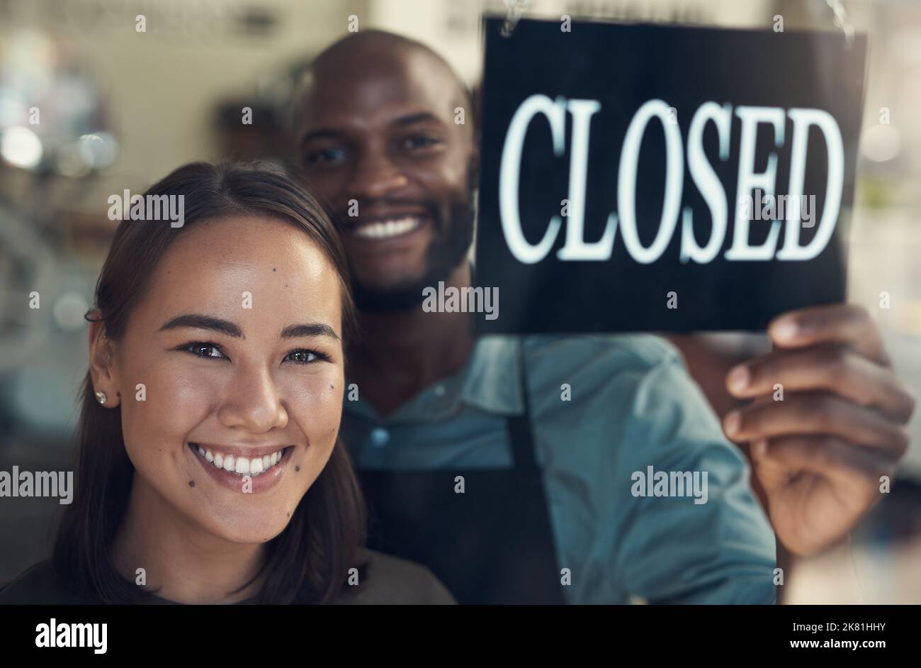 Thank you for visiting us. two young colleagues standing together and ...