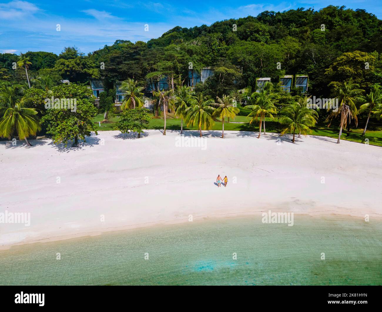 Drone aerial view couple of men and women on a tropical beach in ...