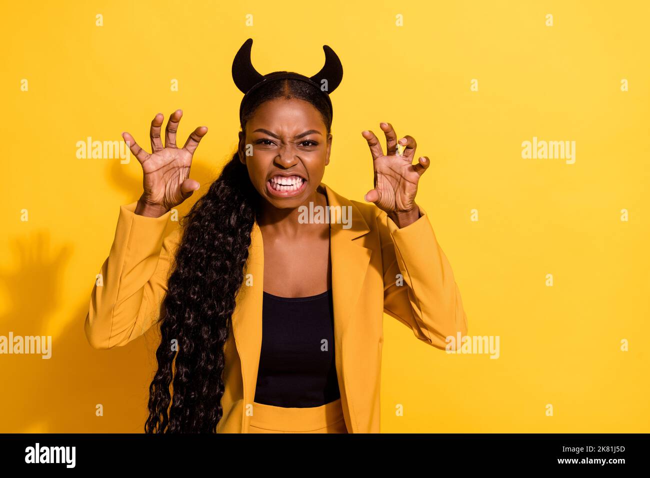 Portrait of attractive classy wavy-haired girl wearing horns scratching ...