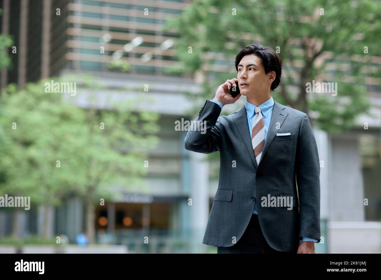 Japanese businessman talking on smartphone Stock Photo - Alamy