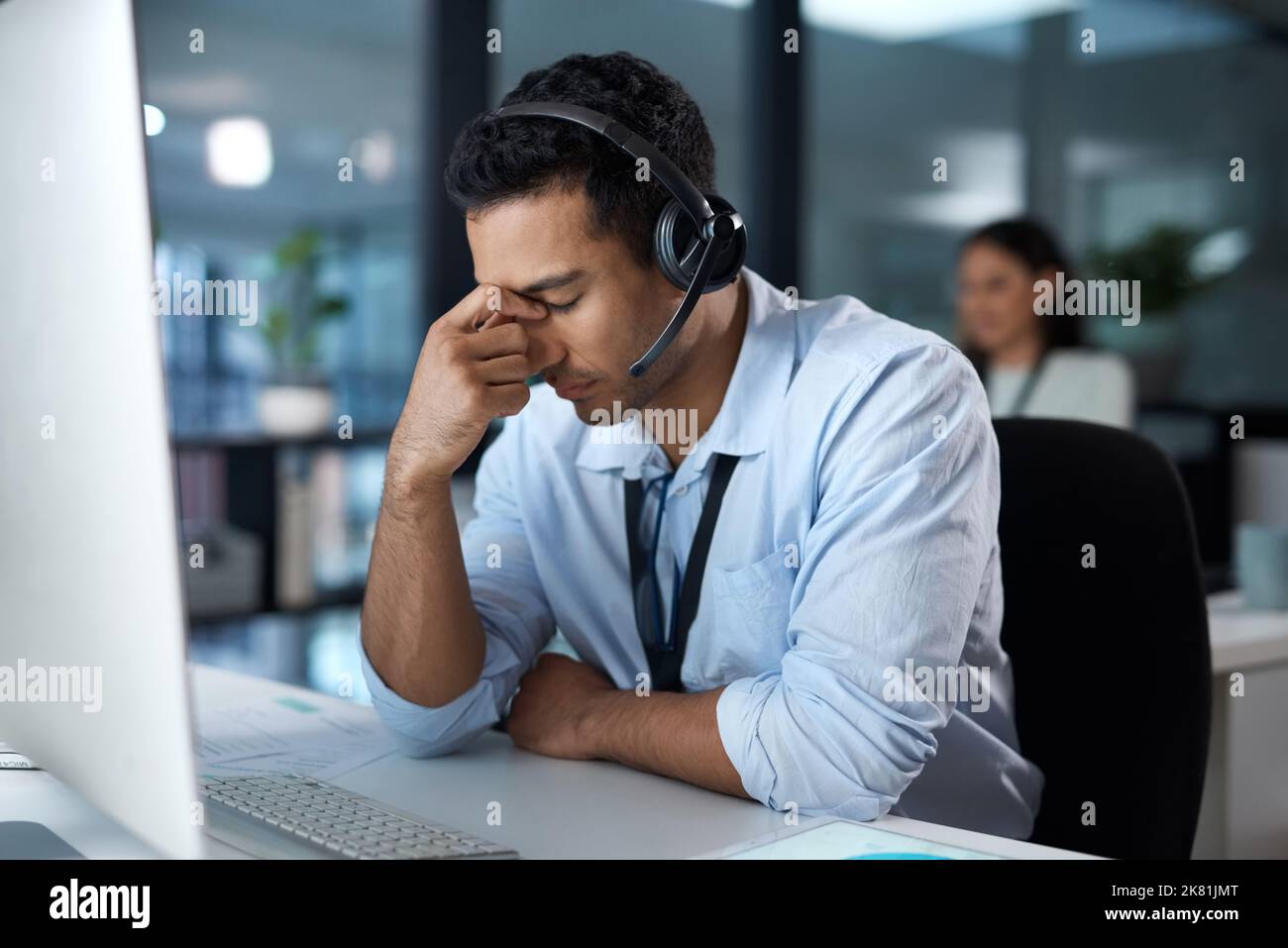 Not every call has a happy ending. a young man using a headset and ...