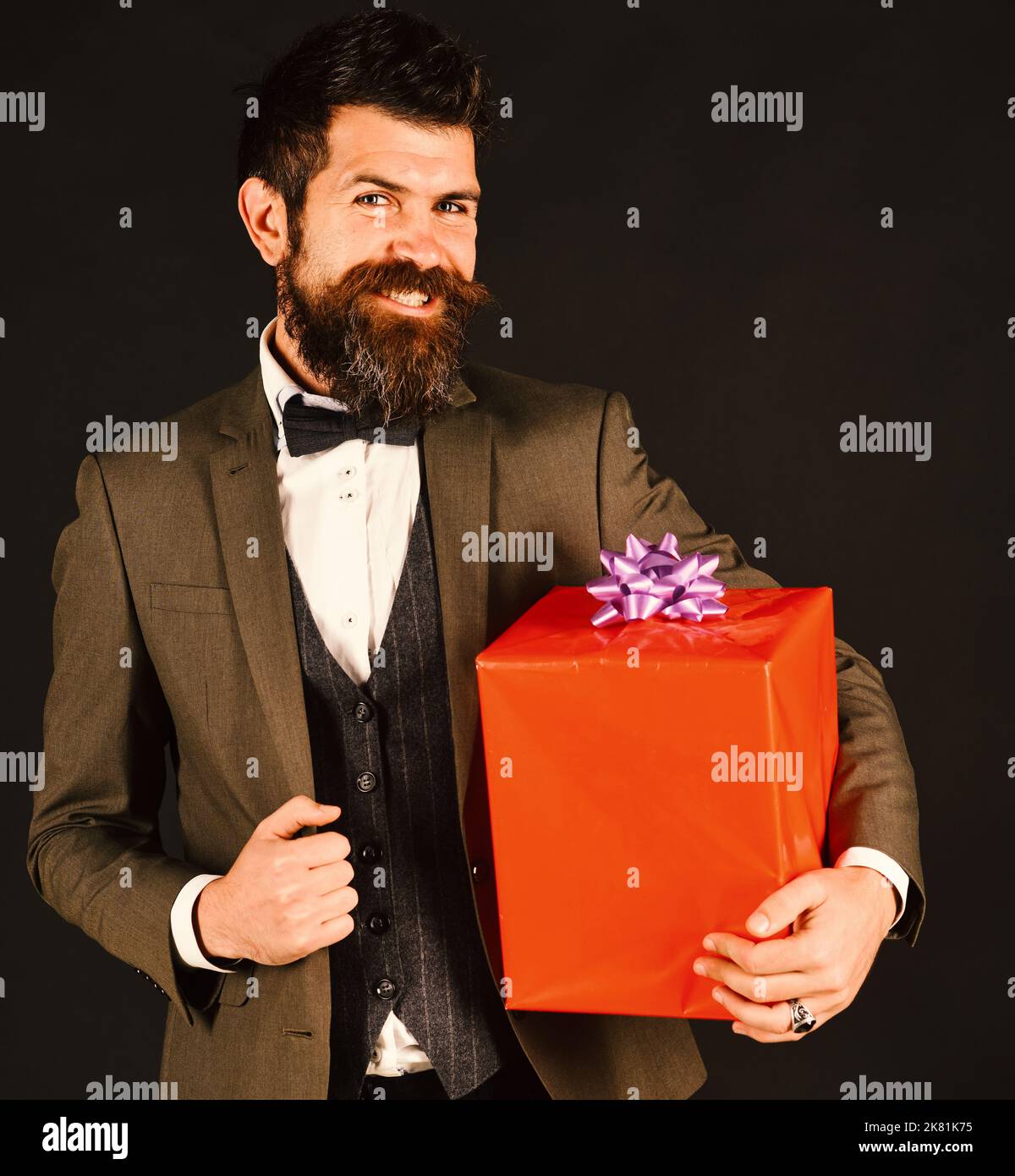 Businessman with happy smiling face and red gift box Stock Photo - Alamy