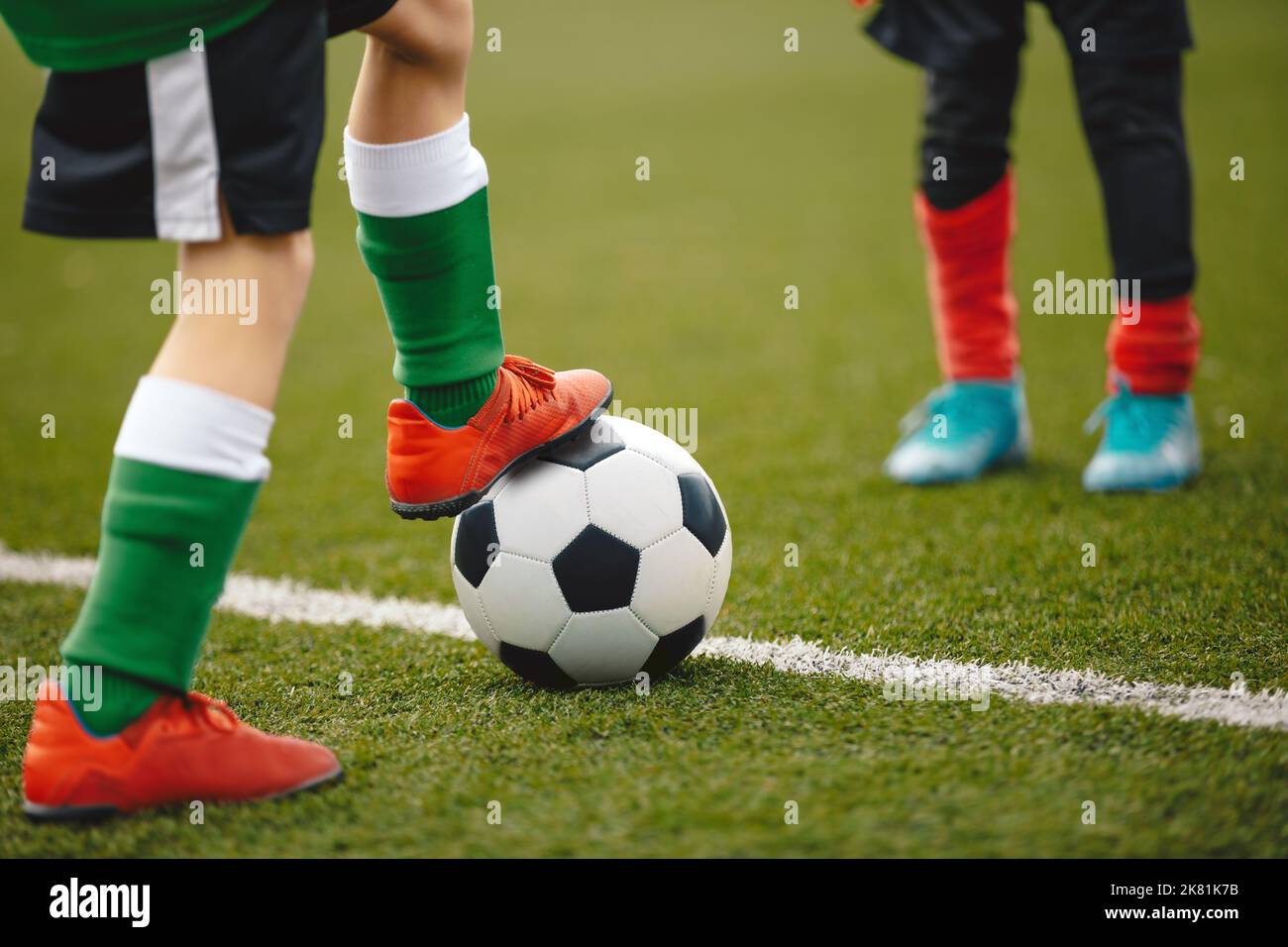 Legs of Soccer Player Kicking Classic Soccer Ball. School Kids ...