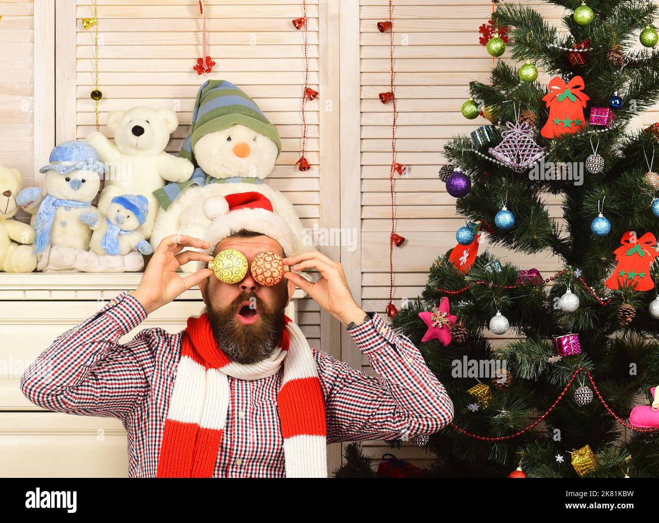 Guy decorates Christmas tree. Festivals and decor concept Stock Photo ...