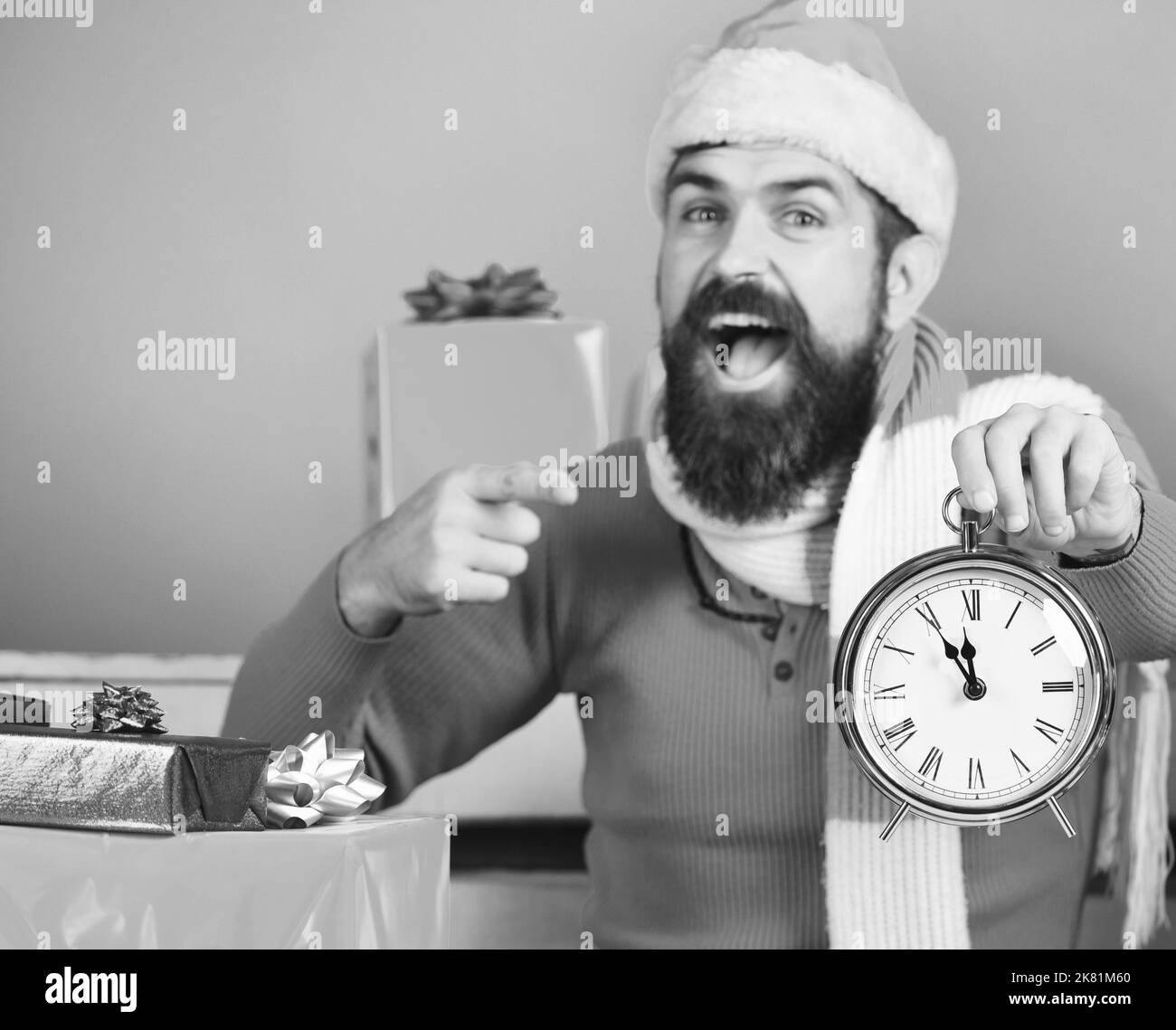 Santa Claus portrait pointing at clock showing five to midnight Stock ...