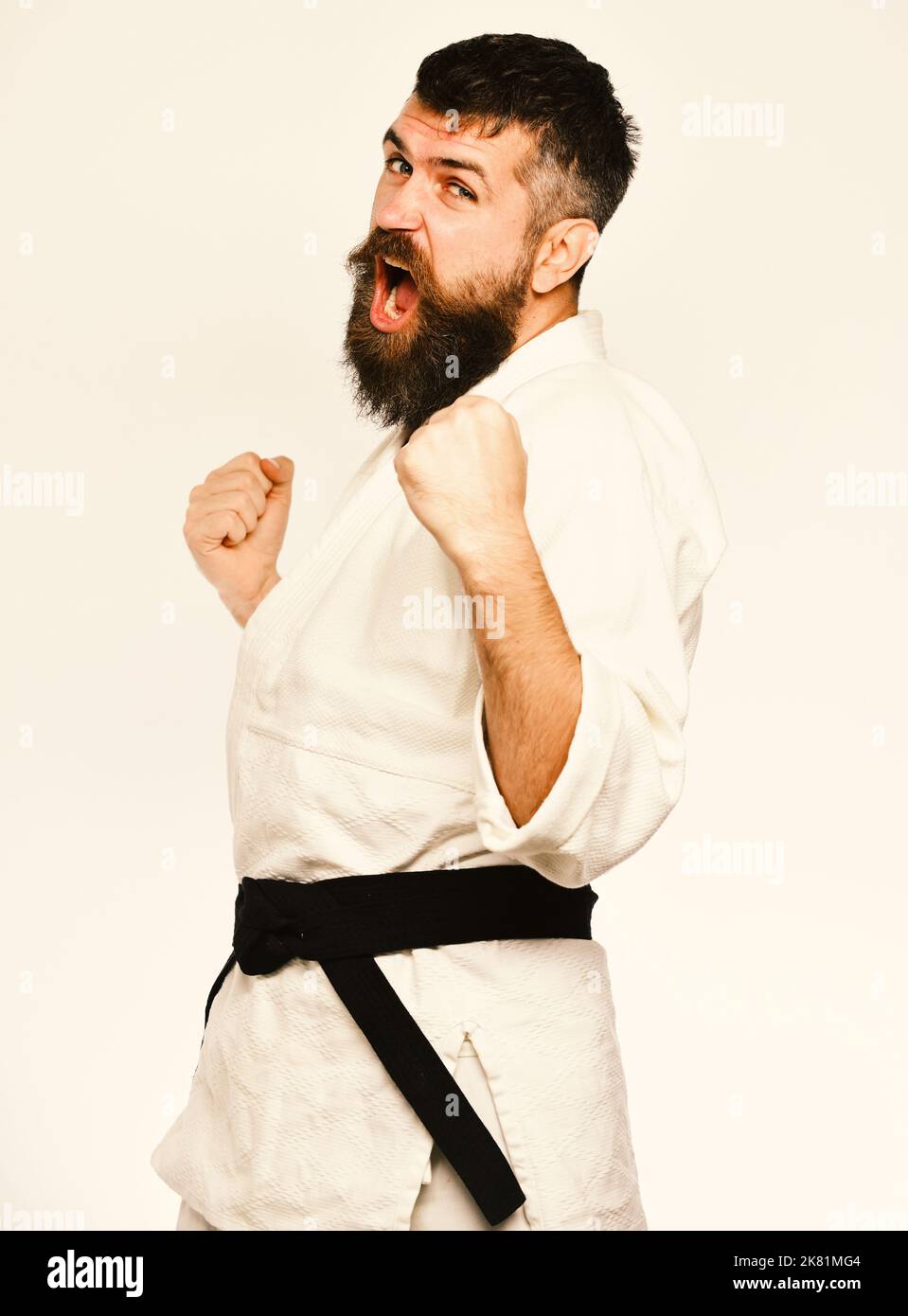 Karate man with angry face in uniform. Man with beard Stock Photo - Alamy