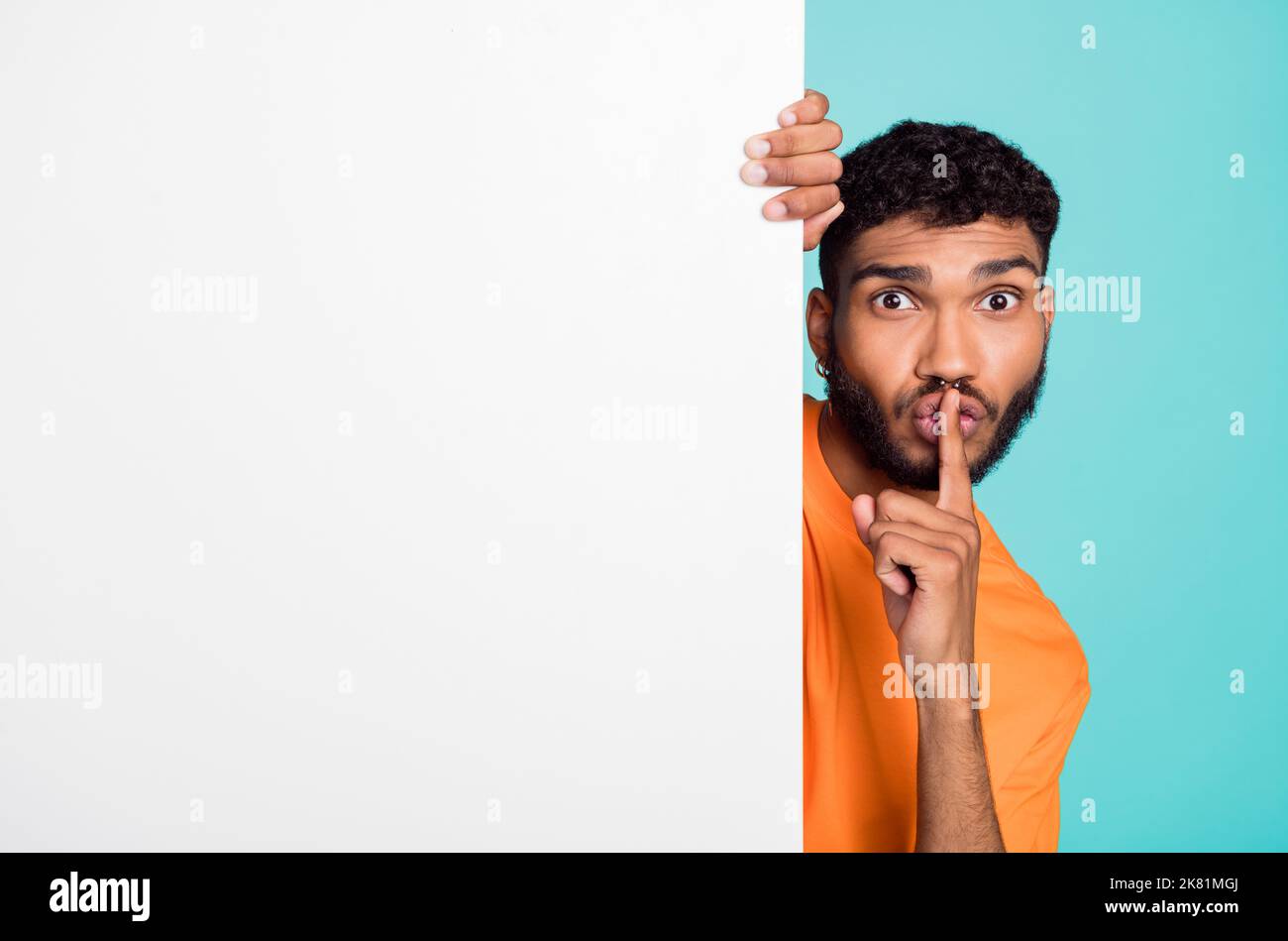 Photo of young man demonstrate shh gesture empty space ad blank ...