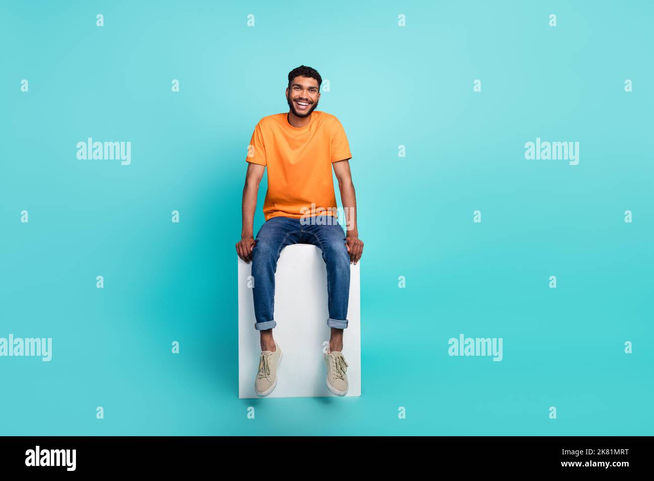 Full body photo of satisfied glad young person sit podium isolated on ...