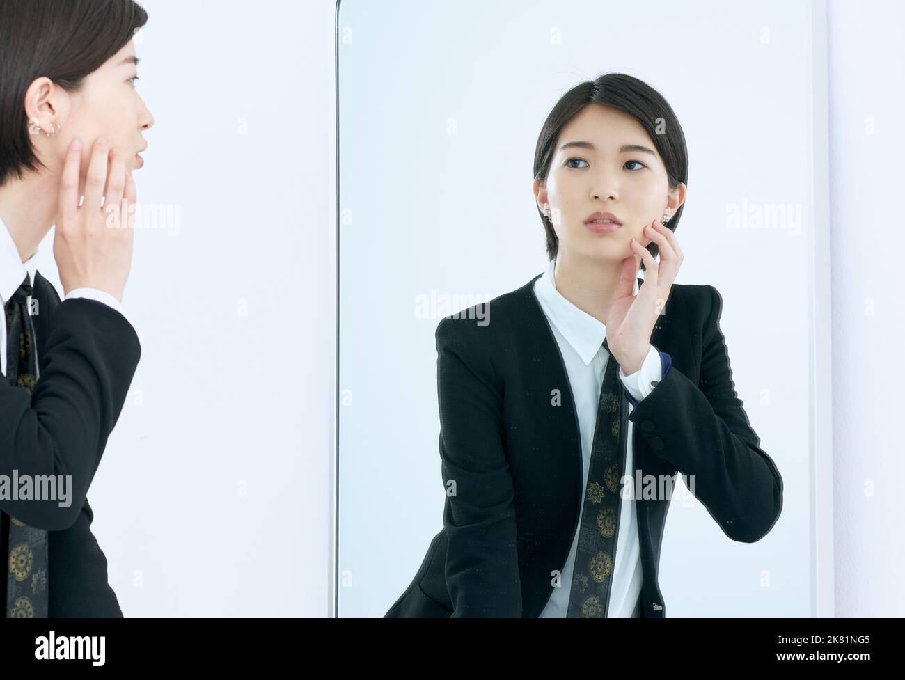 Young Japanese woman looking in the mirror Stock Photo - Alamy